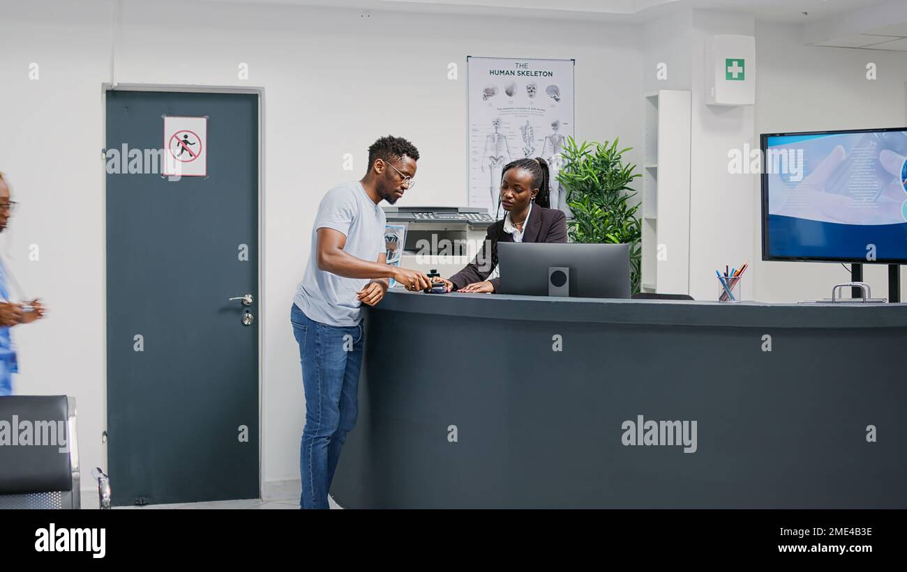 Male patient using mobile phone to pay with nfc on pos terminal, making ...