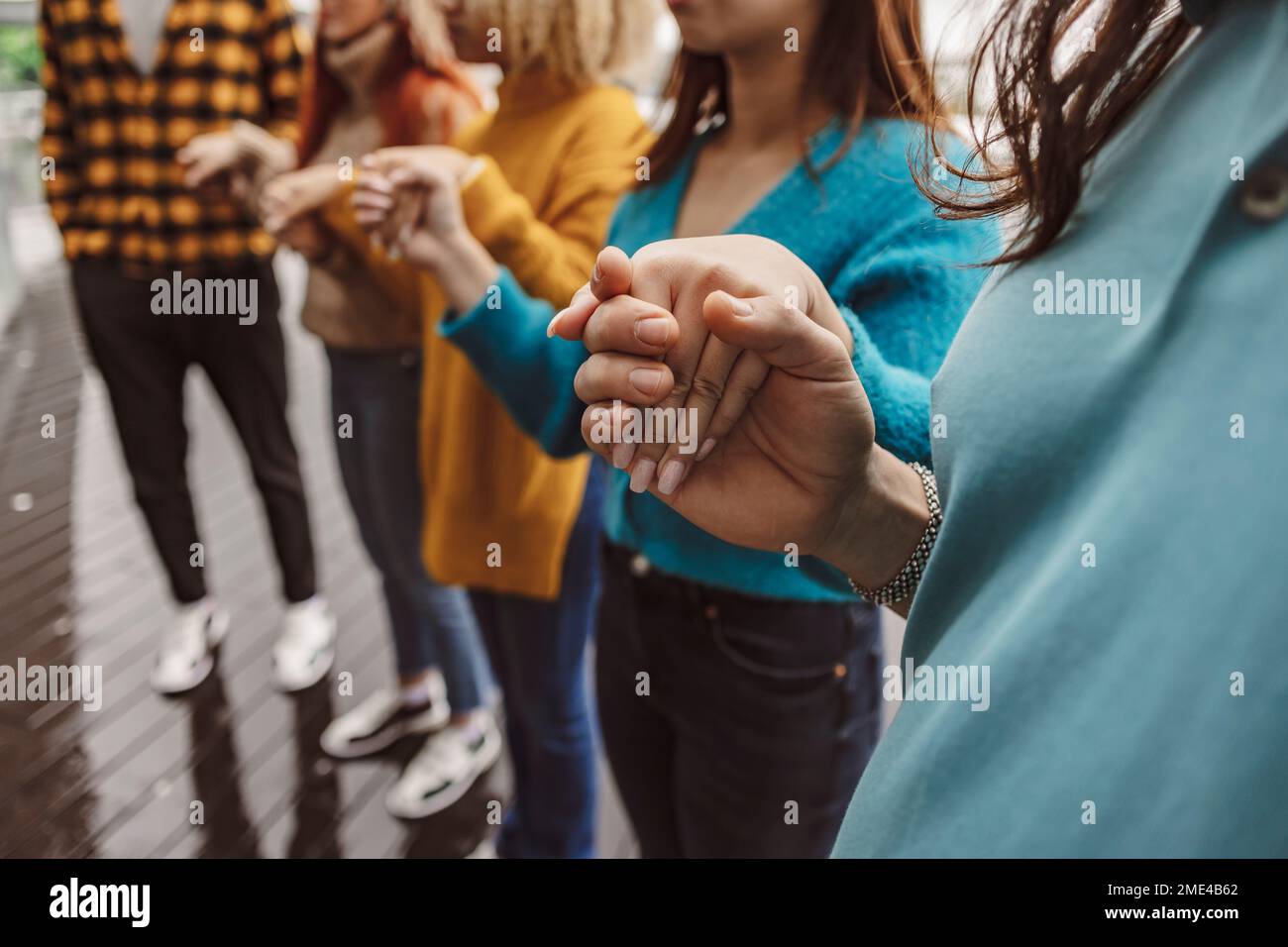 Diverse activists holding hands standing with each other at protest ...