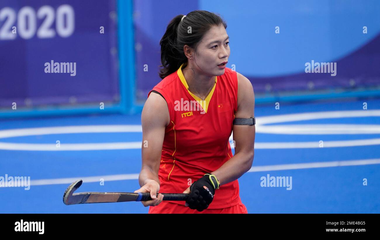 China's Bingfeng Gu looks to pass the ball during a women's field ...