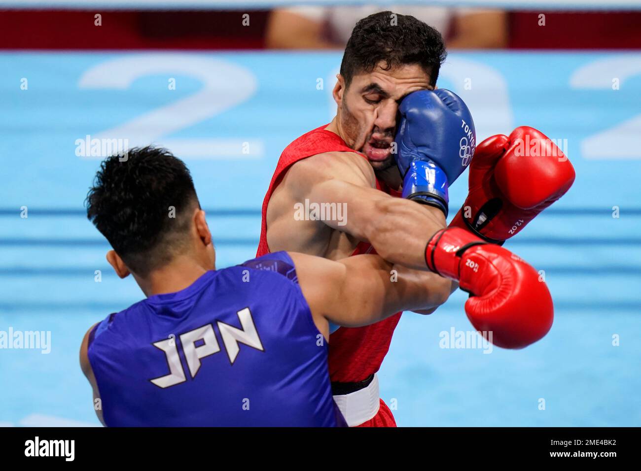 Yuito Moriwaki, of Japan, left, connects with a punch during middle ...