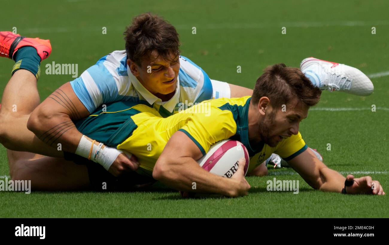 Australia's Josh Turner scores a try as Argentina's Luciano Gonzalez ...