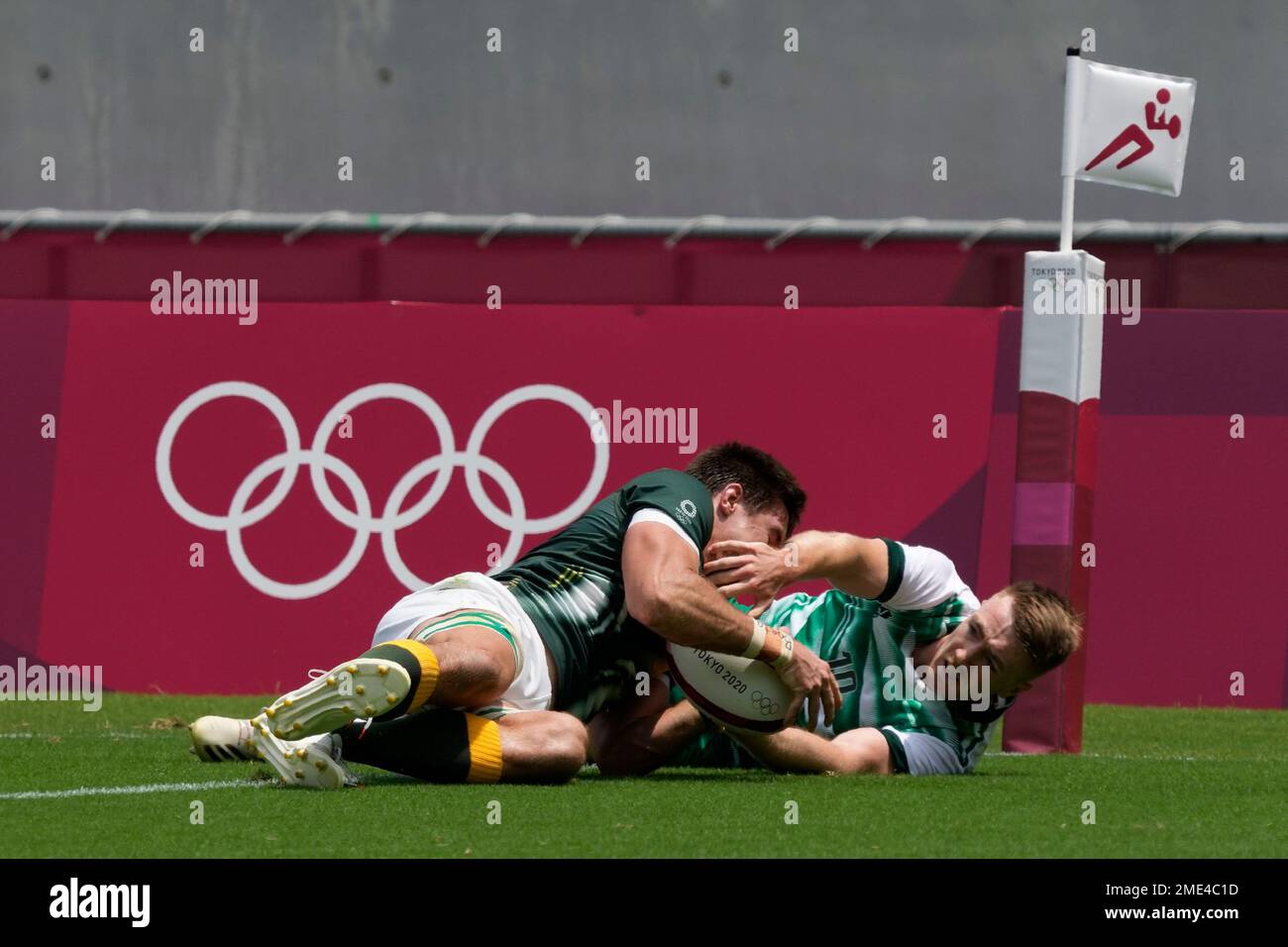 South Africa's Impi Visser, left, scores a try past Ireland's Terry ...