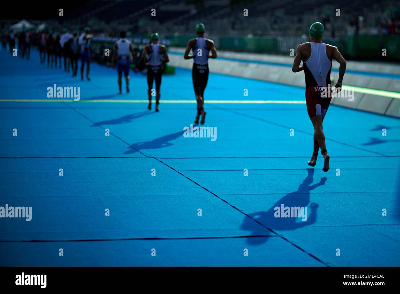 Diego Moya, of Chile, jogs to the start line with fellow competitors ...