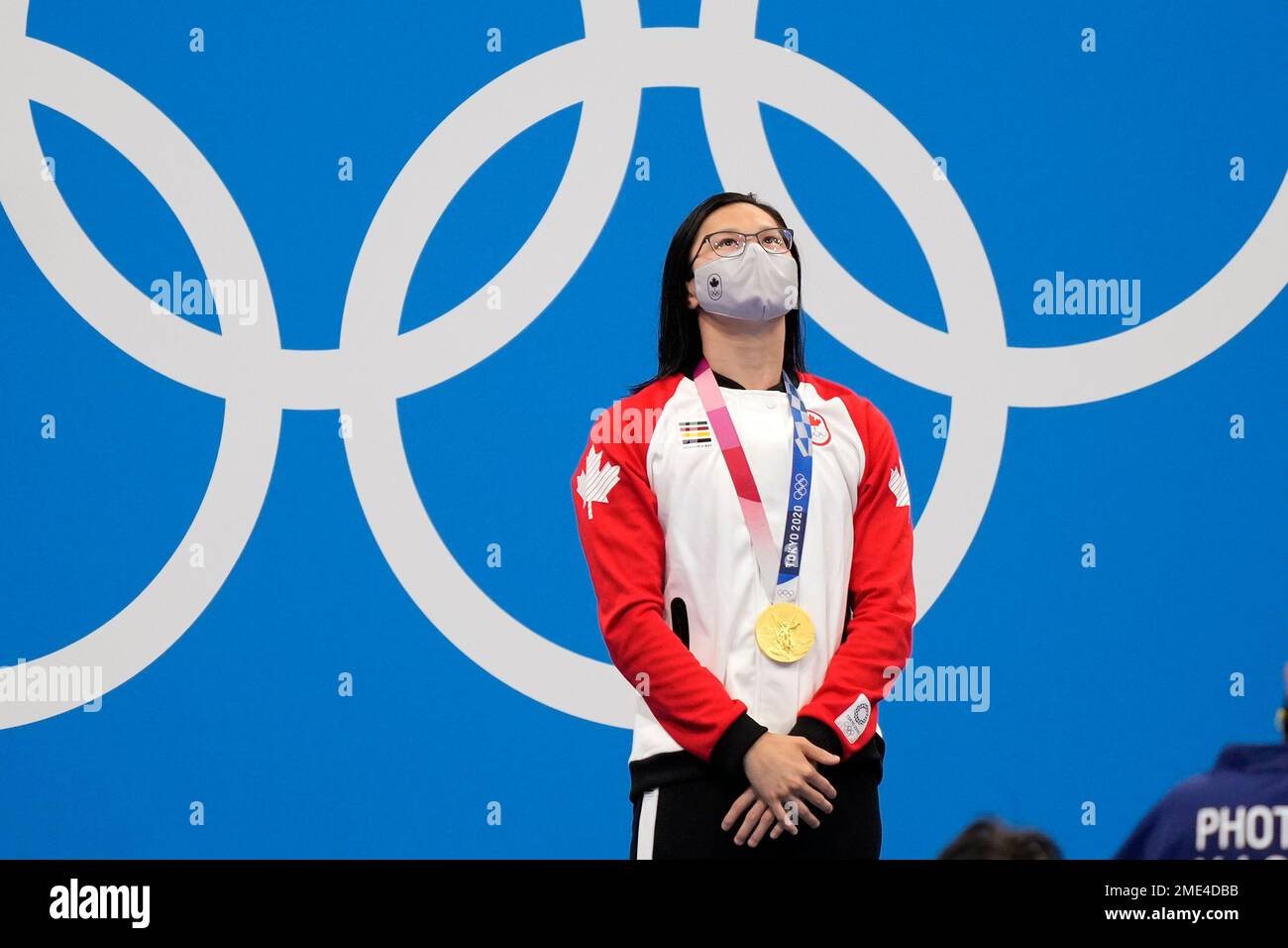 Margaret MacNeil of Canada looks up while on the podium after winning ...