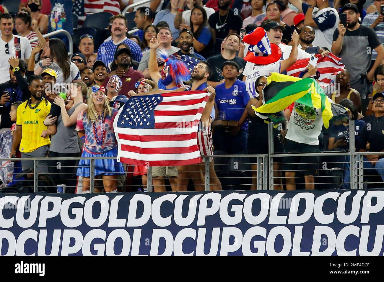 Fans wave American and Jamaican flags during team warmups before a 2021 ...