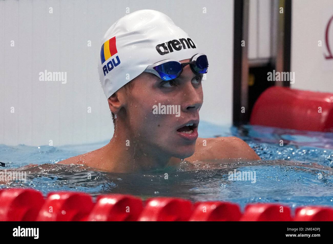 David Popovici of Romania rests after his swim in a semi-final during ...