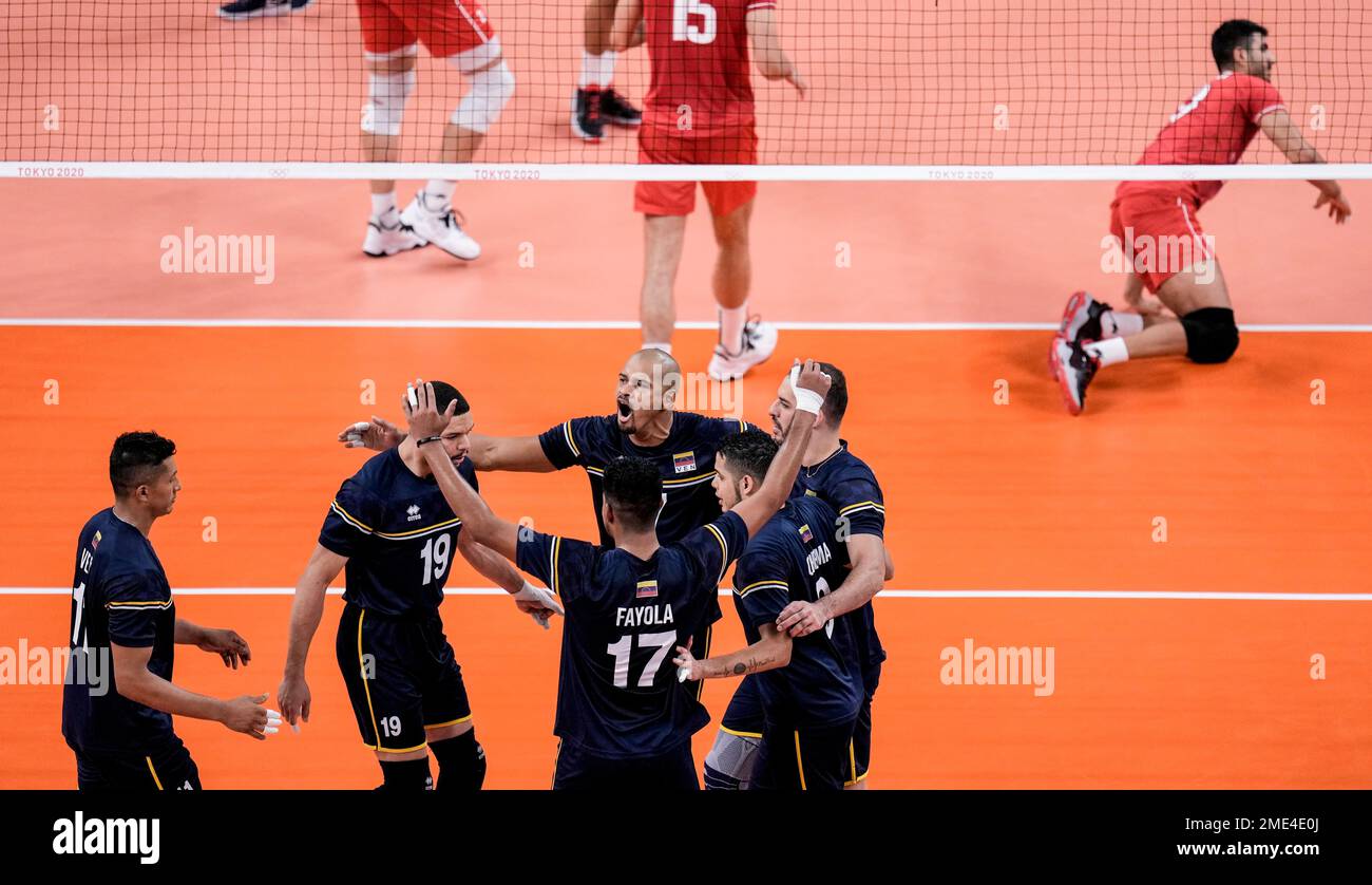 Venezuela's team players celebrate a point during the men' svolleyball ...