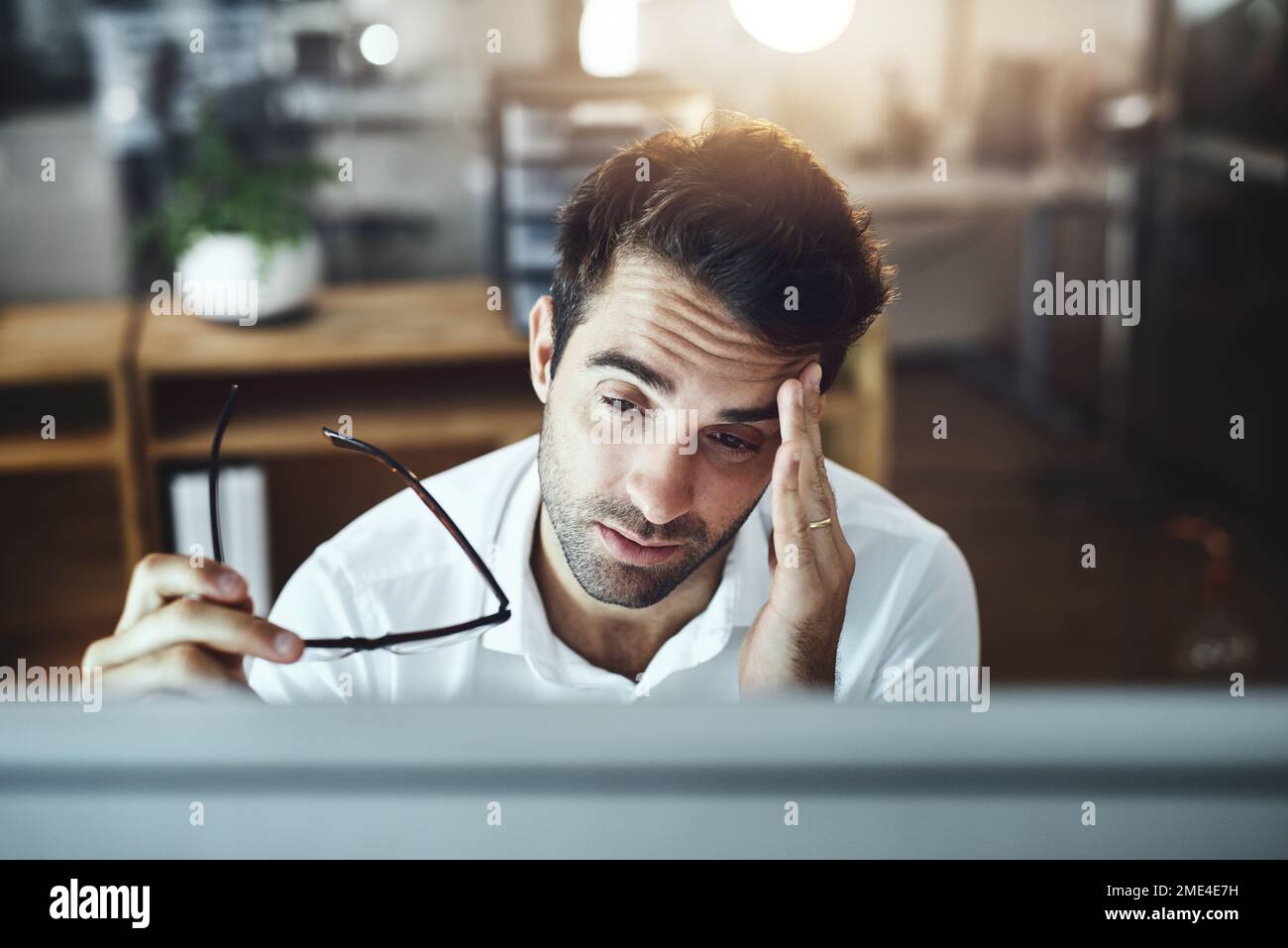 This is is completely stressing me out. a young businessman looking ...