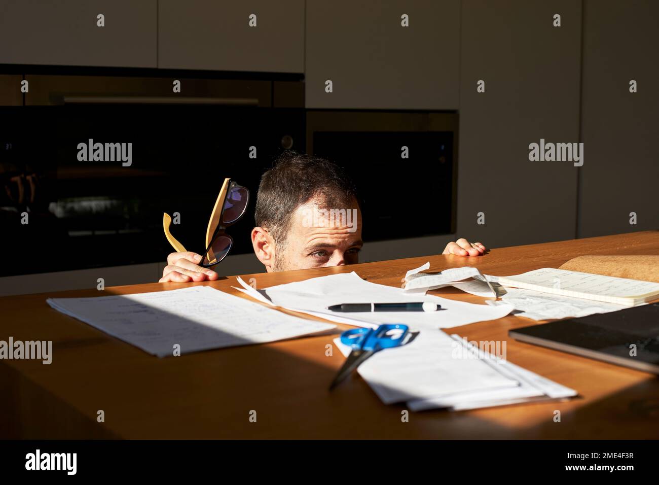 Worried man hiding bills hi-res stock photography and images - Alamy