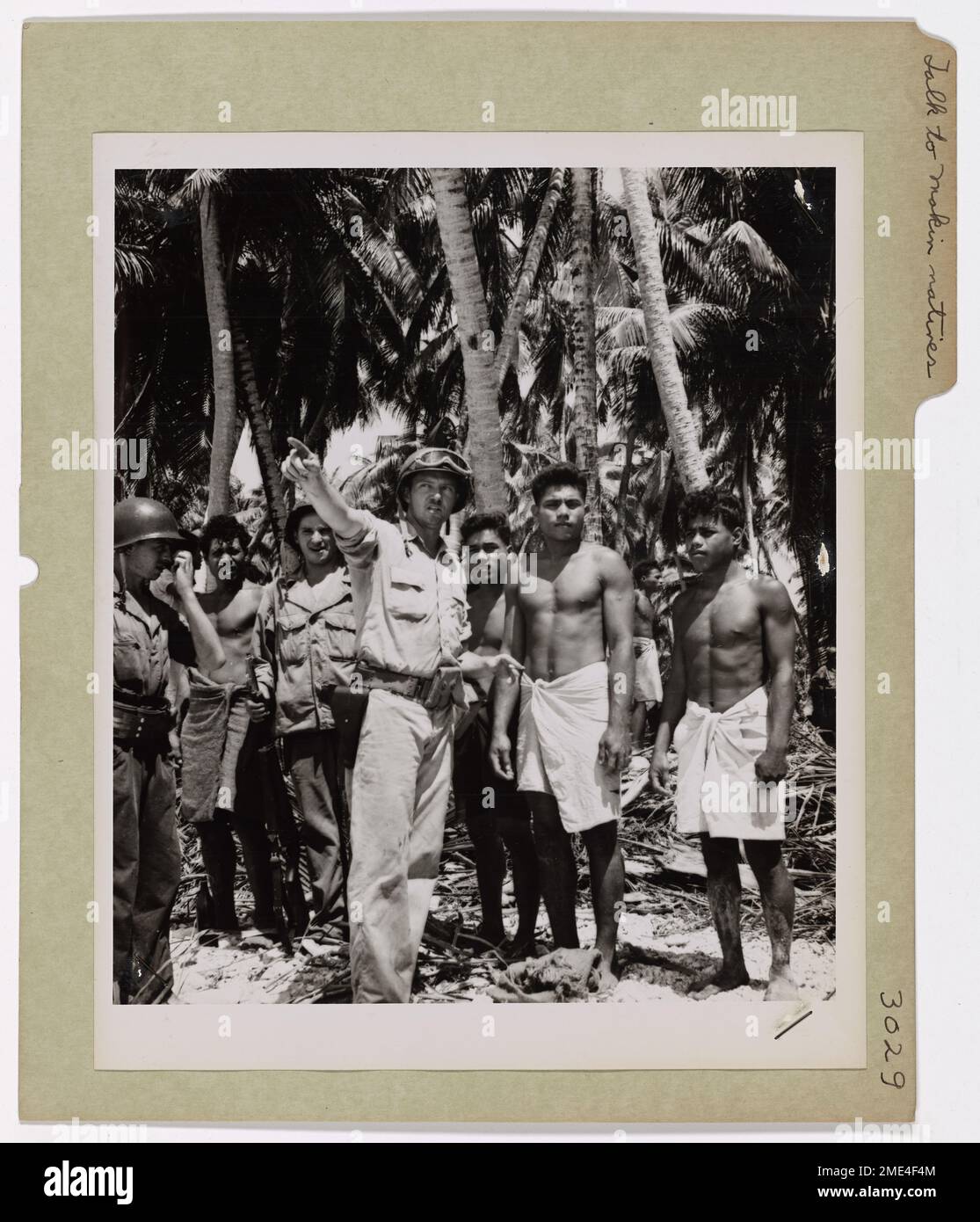 U.S. Coast Guardsmen engage in conversation with natives on Makin ...
