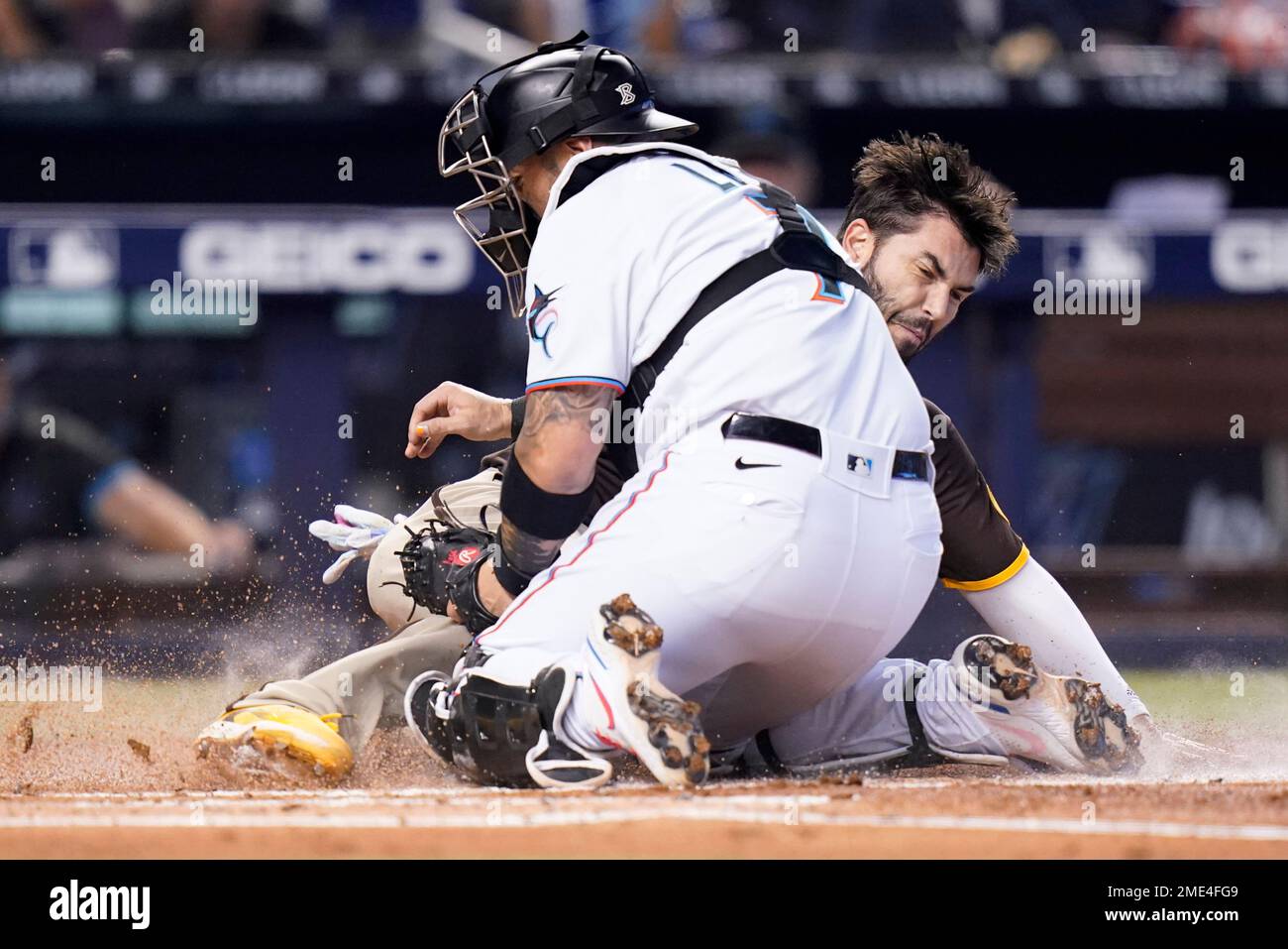 Miami Marlins catcher Sandy Leon, left, tags out San Diego Padres ...
