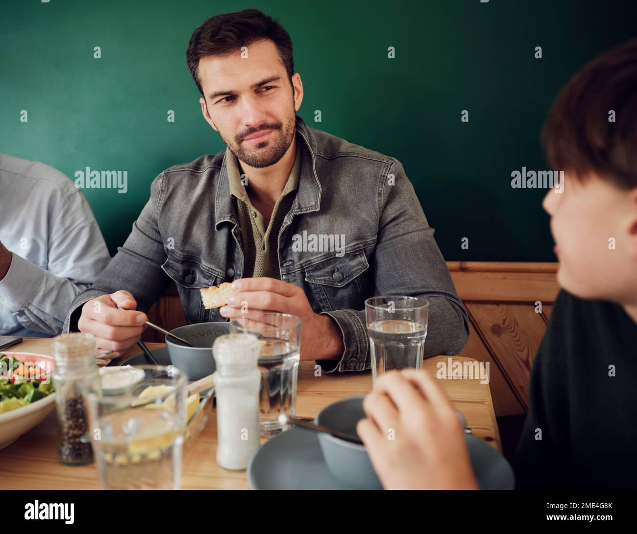 Father and son eating lunch in kitchen Stock Photo - Alamy