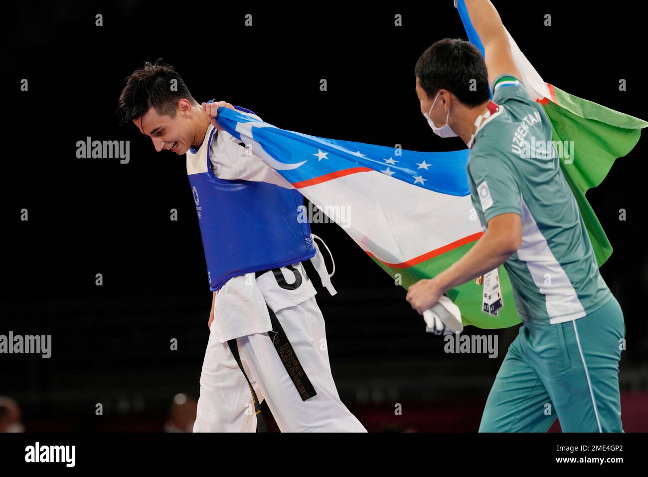 Uzbekistan's Ulugbek Rashitov, with coach celebrate for defeating ...