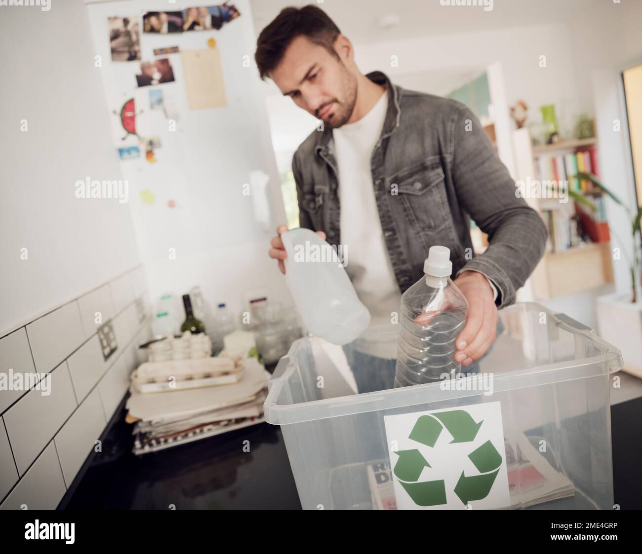 Man putting separated waste into recycling box Stock Photo - Alamy