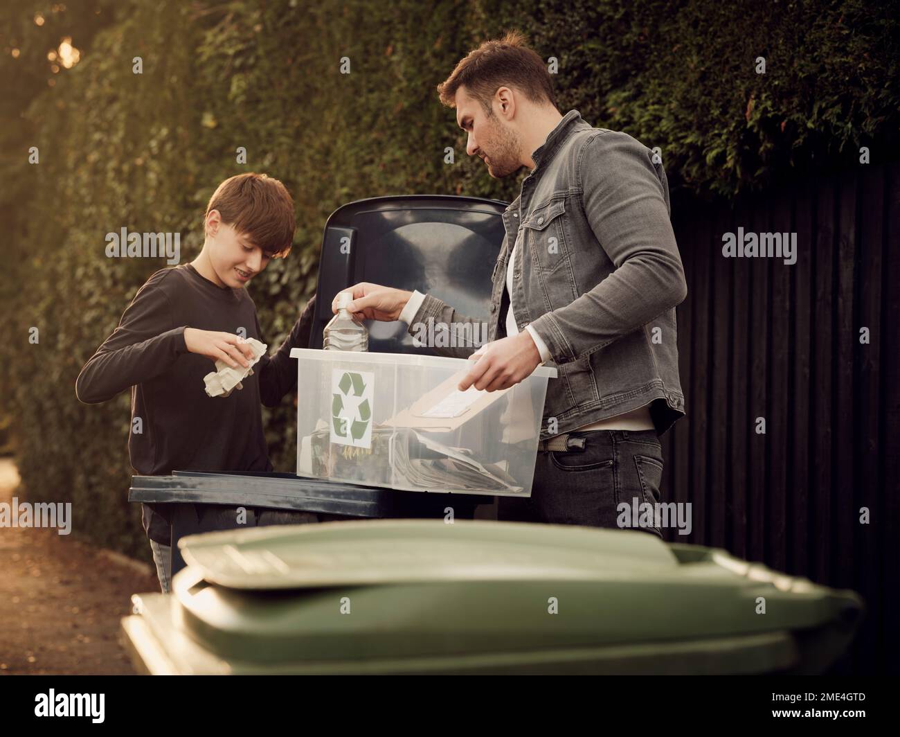 Boy putting waste recycling hi-res stock photography and images - Alamy