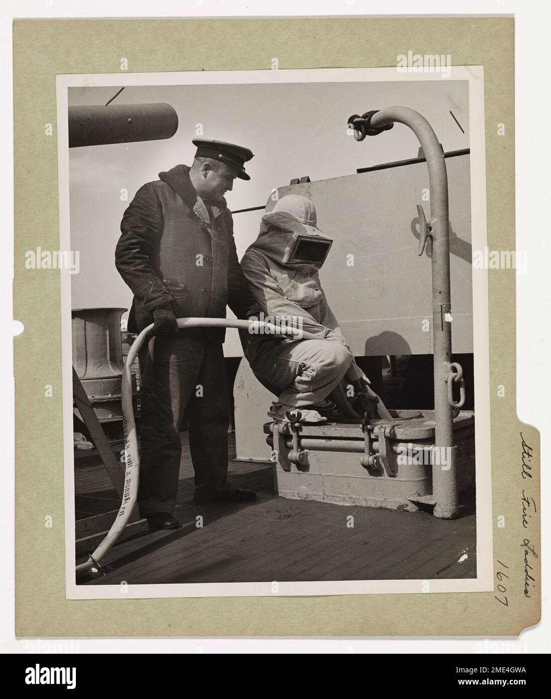 George E. Tacey and Andrew A. Bong are pictured working on a fire ...