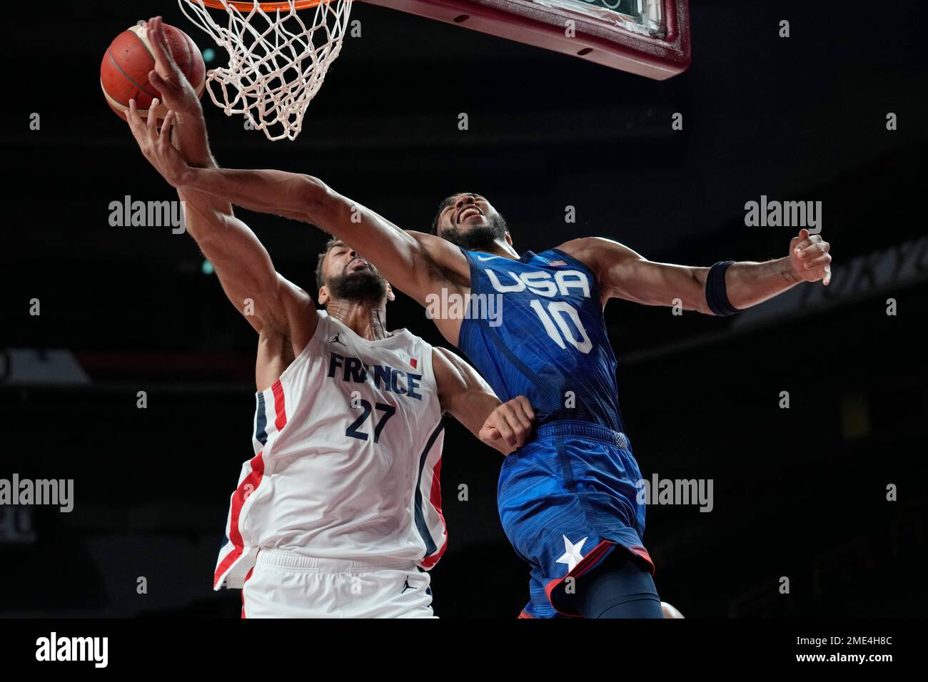 United States' Jayson Tatum (10) is fueled by France's Rudy Gobert (27 ...