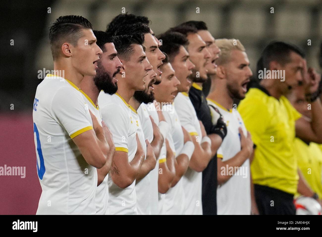 Romania's team sing their national anthem prior a men's soccer match ...