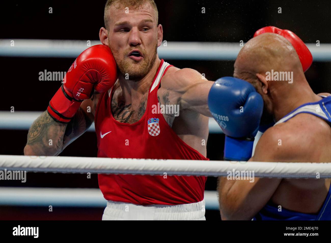 Croatia's Luka Plantic, left, exchanges punches with Jordan's Odai ...