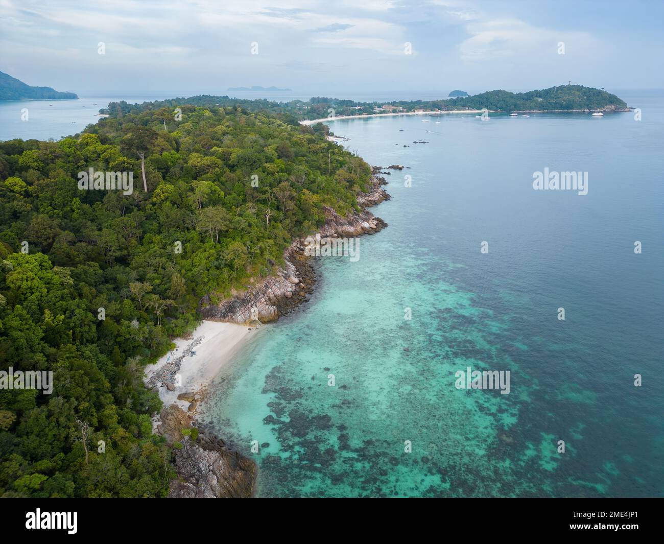 An aerial of the Galah Beach with green trees on Ko Lipe island in ...