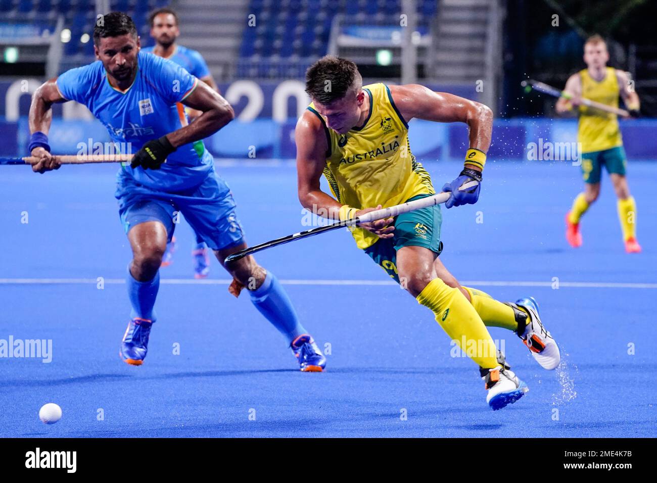 Australia's Tim Brand (29) drives the ball past India's Rupinder Pal ...