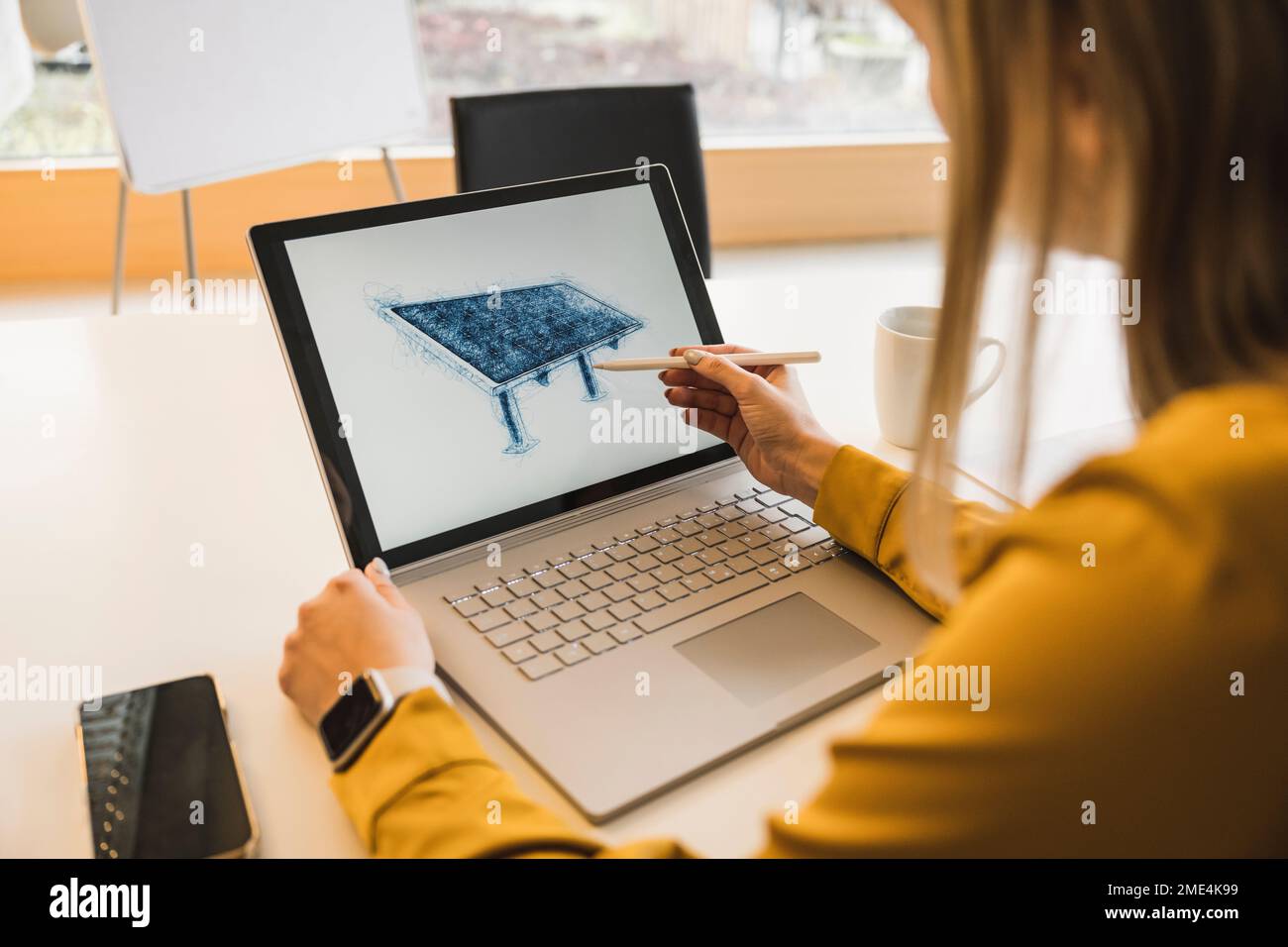 Young businesswoman drawing solar panel on laptop with digitized pen ...