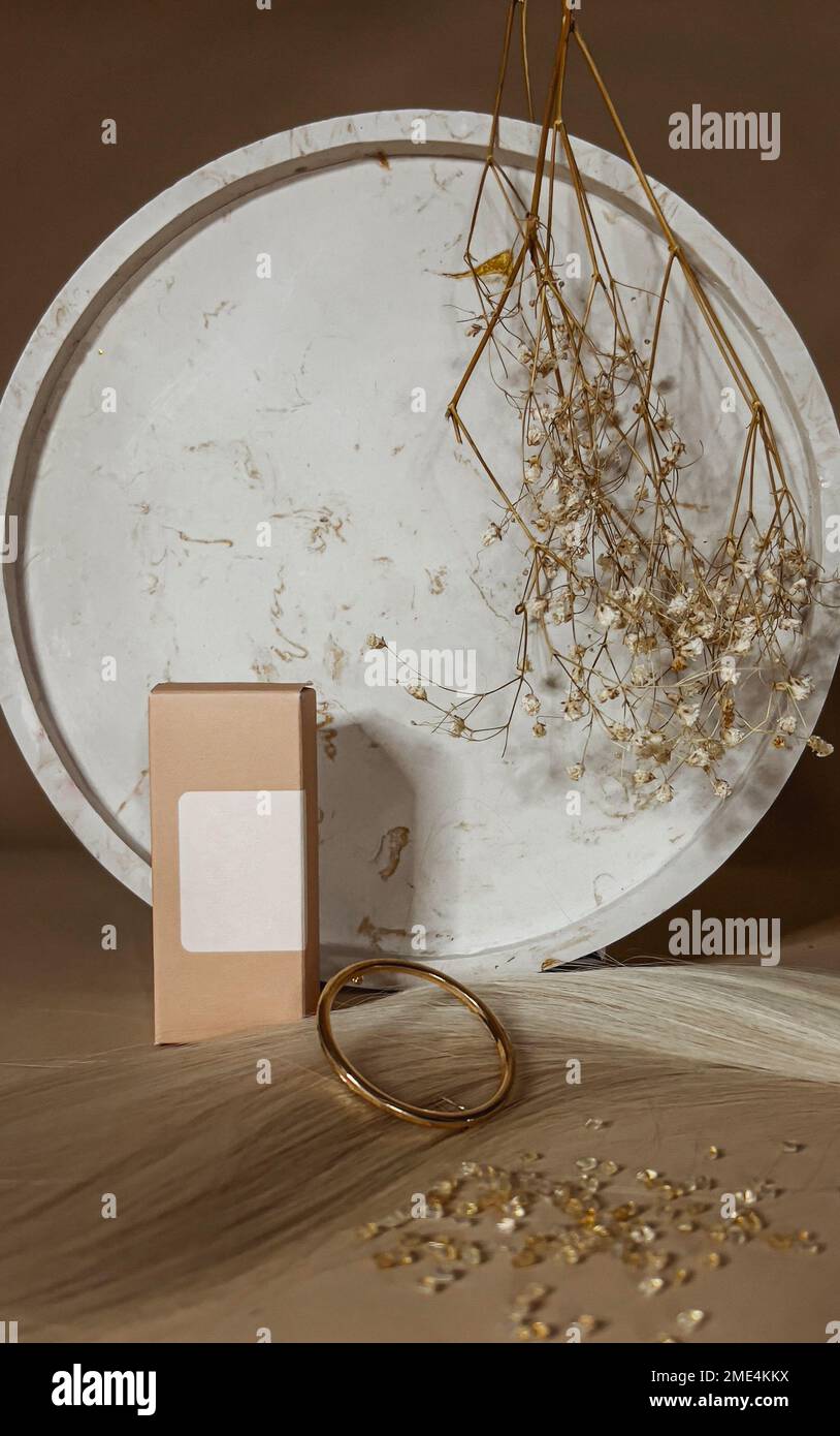 A strand of natural light hair for extensions with a box of care ...