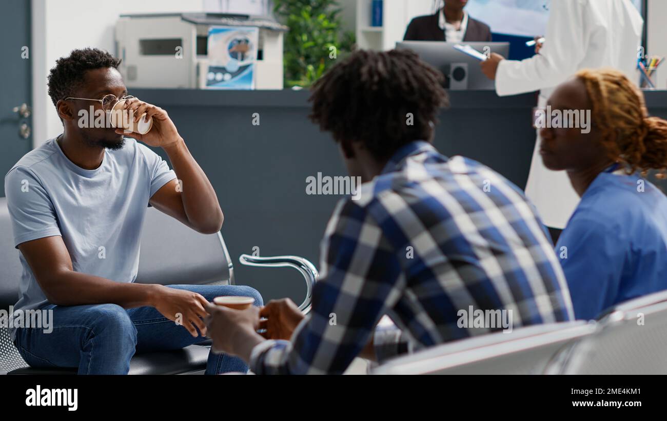 Group of sick patients sitting together in waiting room at hospital ...