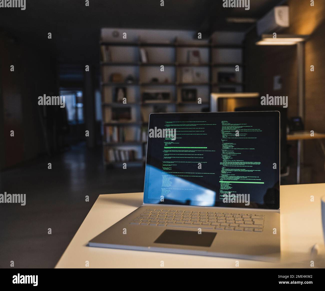 Laptop with data on screen kept at desk in office Stock Photo - Alamy