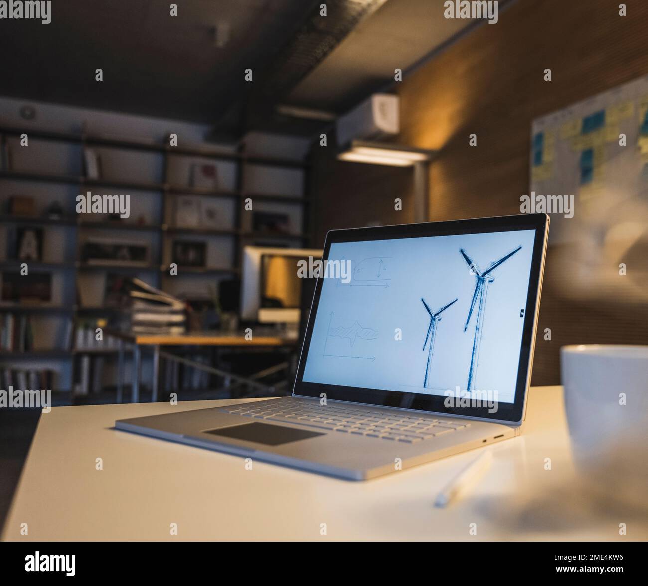 Laptop with design of wind turbine kept on desk Stock Photo - Alamy