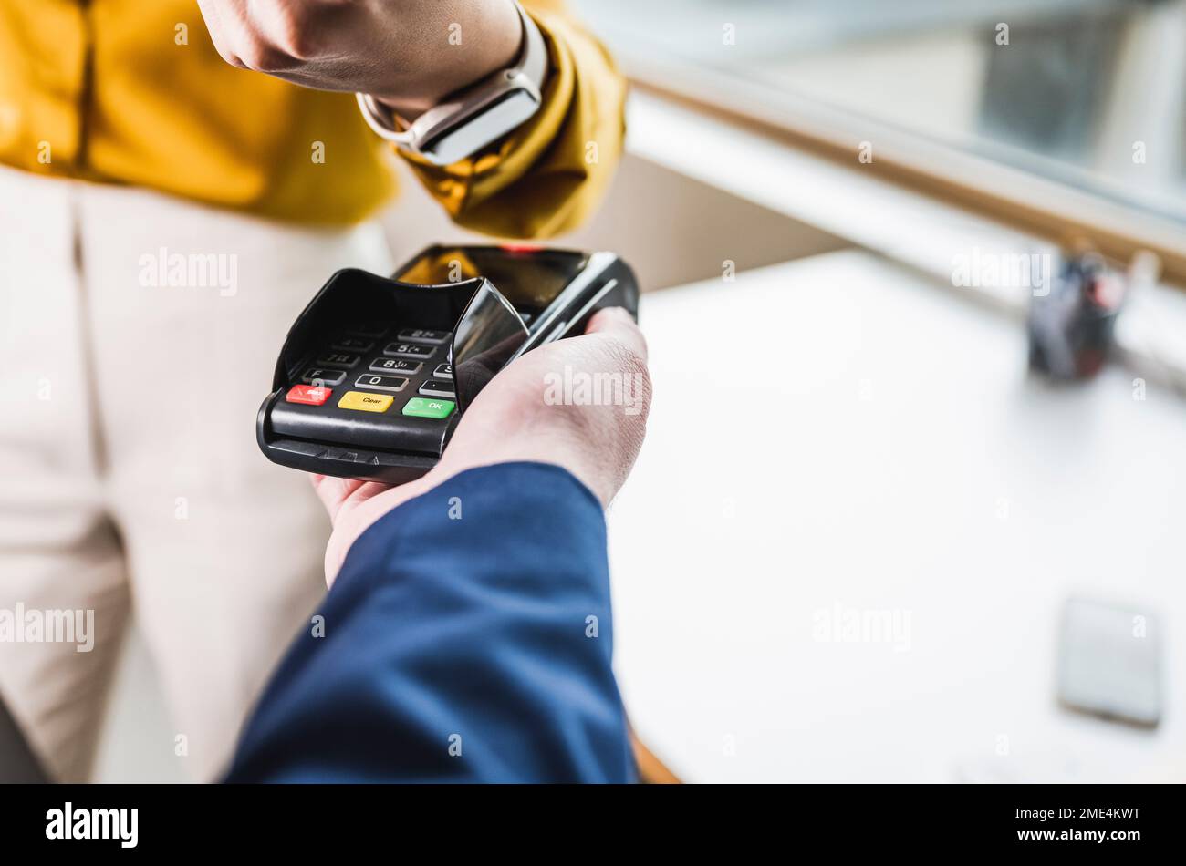 Businesswoman paying with smart watch on card reader machine Stock ...