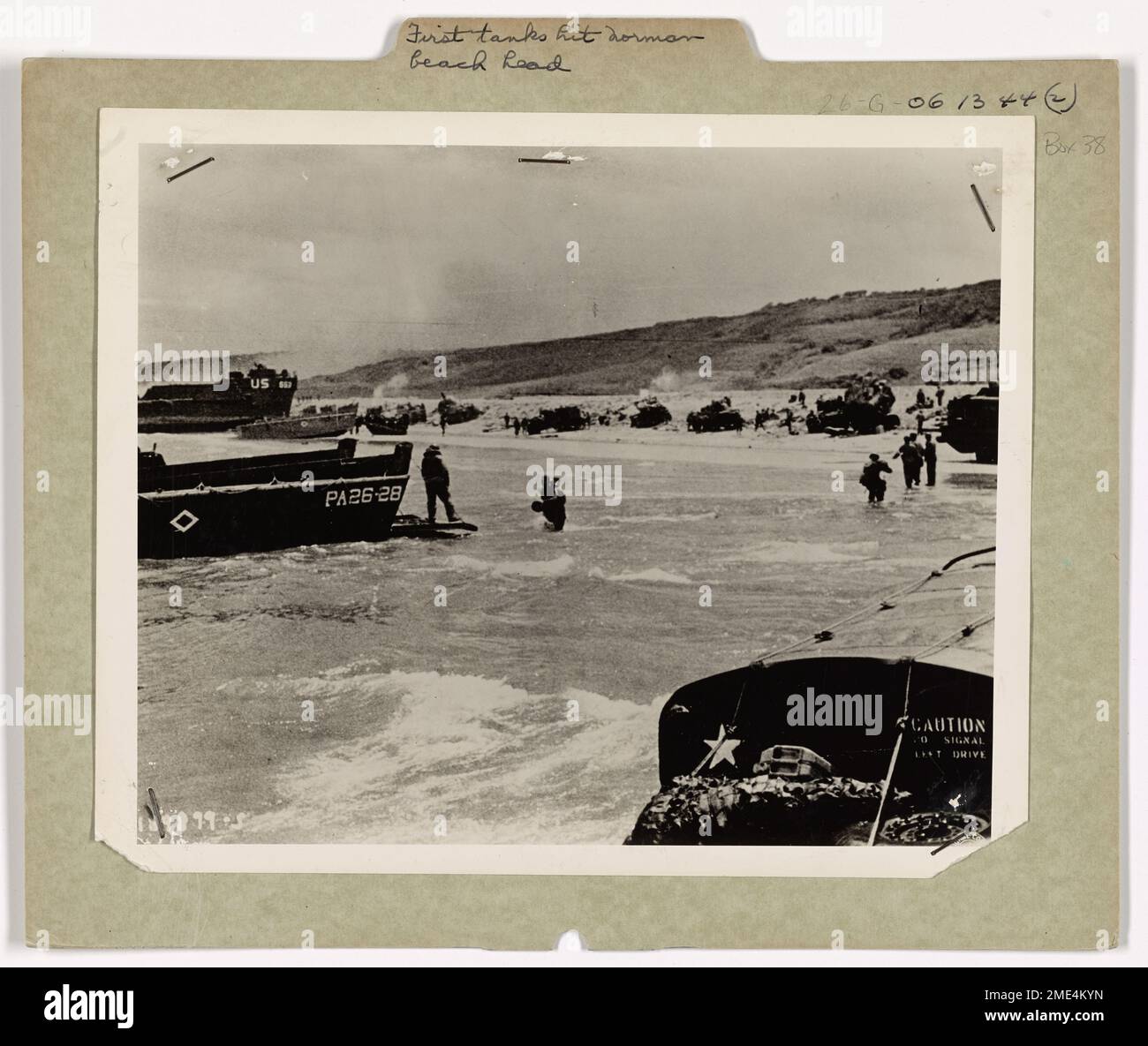 U.S. tanks roll off Coast Guard landing crafts onto the sands of ...
