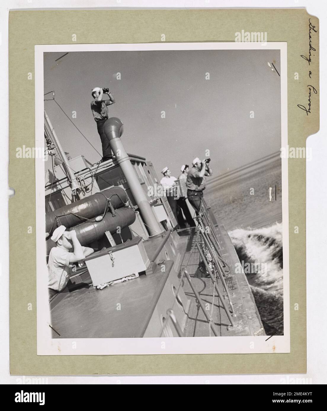 Coast Guardsmen stand alert at their battle stations, ready to defend a ...