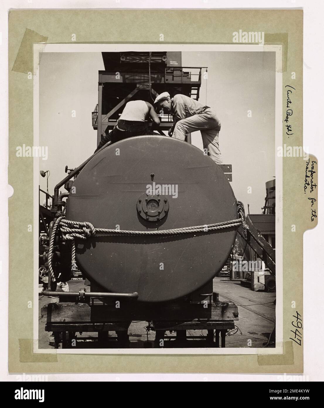 Workmen at the Coast Guard's Curtis Bay shipyard rig a sling for ...
