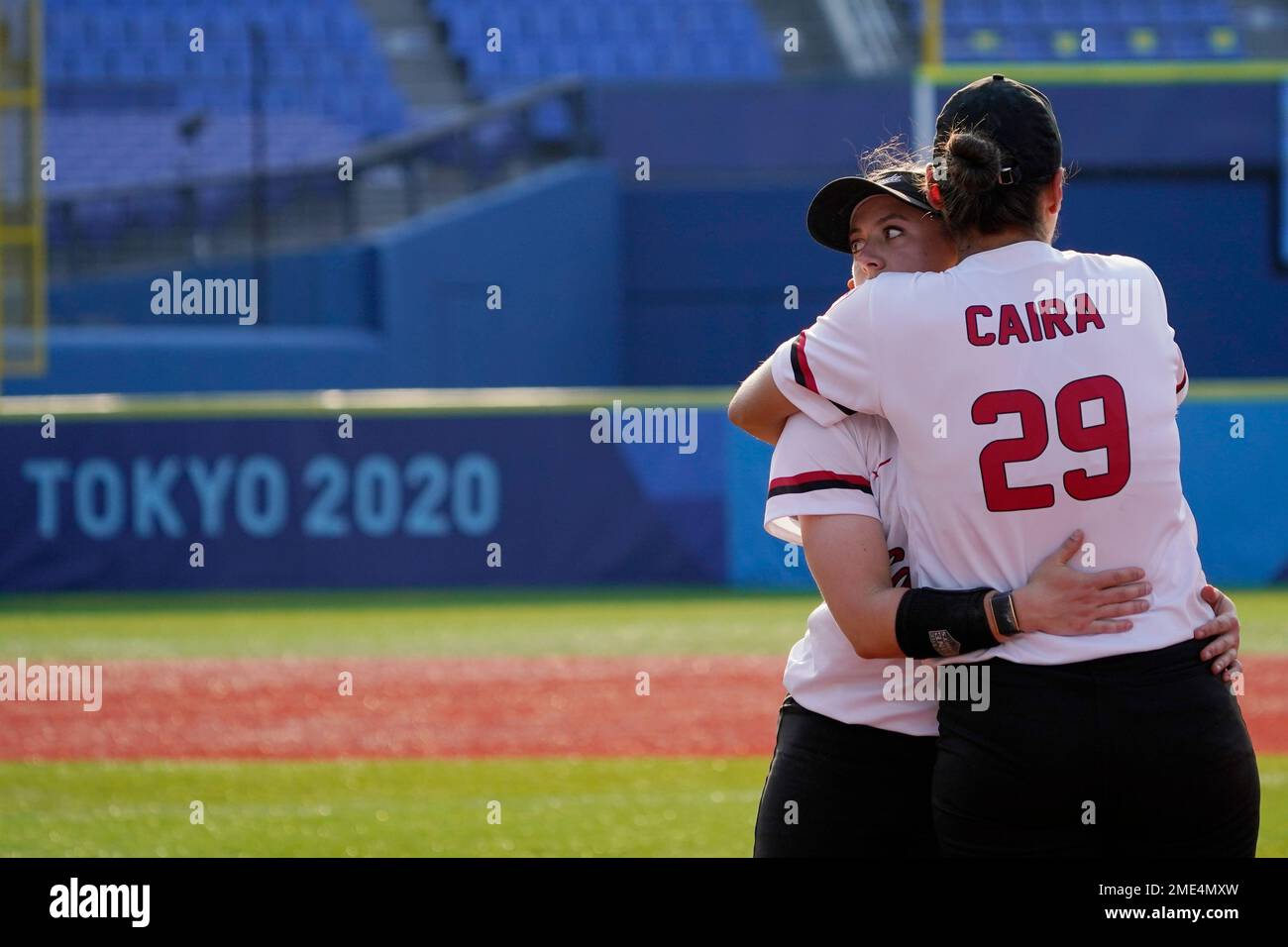Canada's Erika Polidori, left, and Jenna Caira (29) embrace after being ...