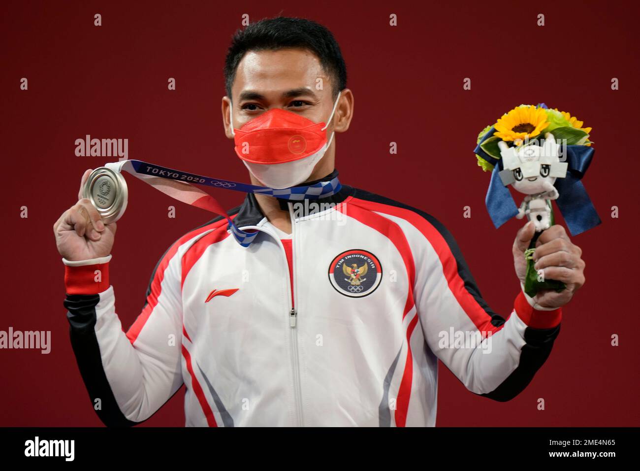 Eco Yuli Irawan of Indonesia celebrates on the podium after winning the ...