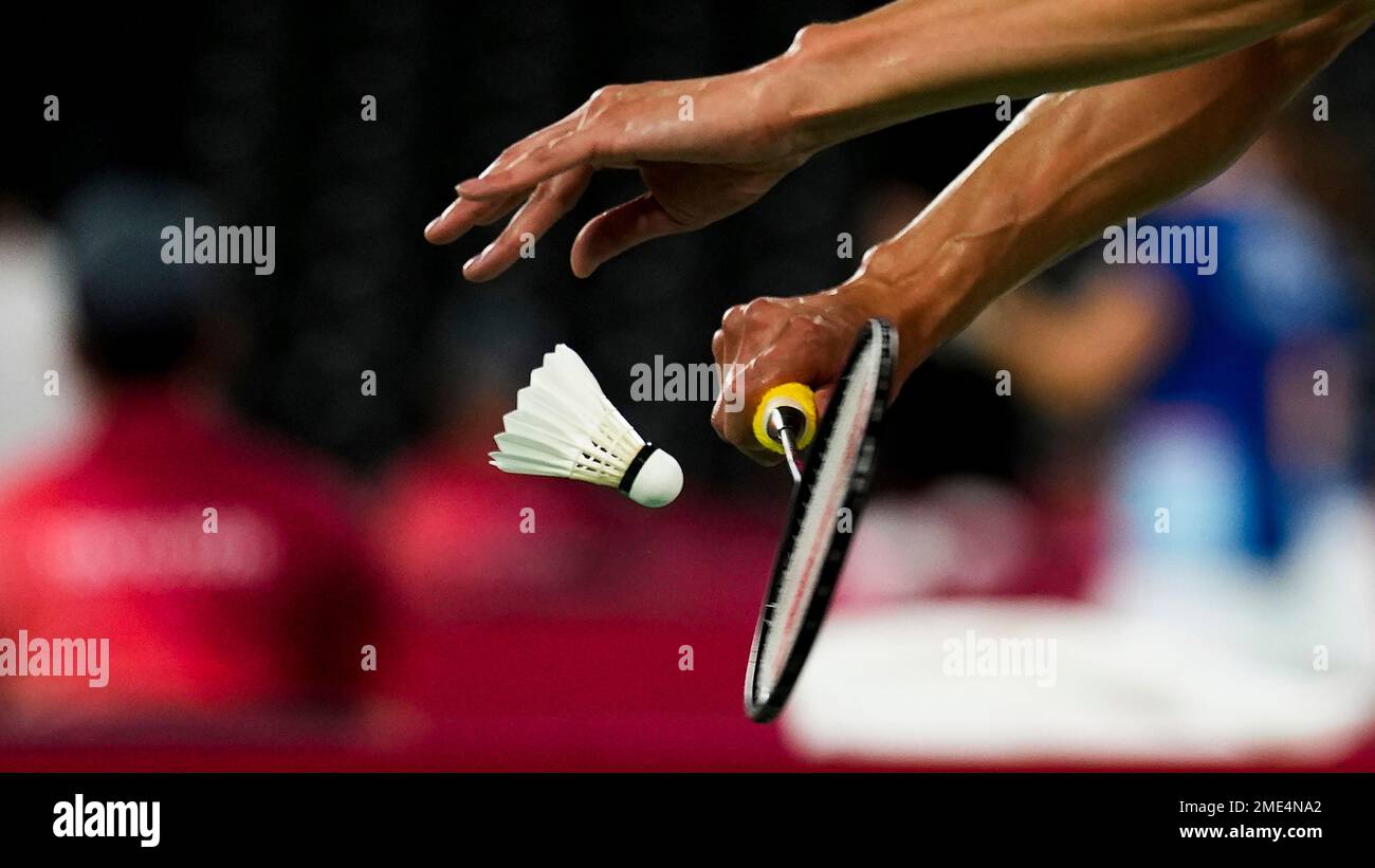 China's Chen Long plays the shuttlecock as he competes against Estonia ...