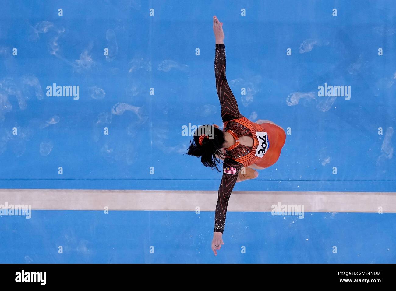 Farah Ann Abdul Hadi, of Malaysia, falls as she performs on the beam ...