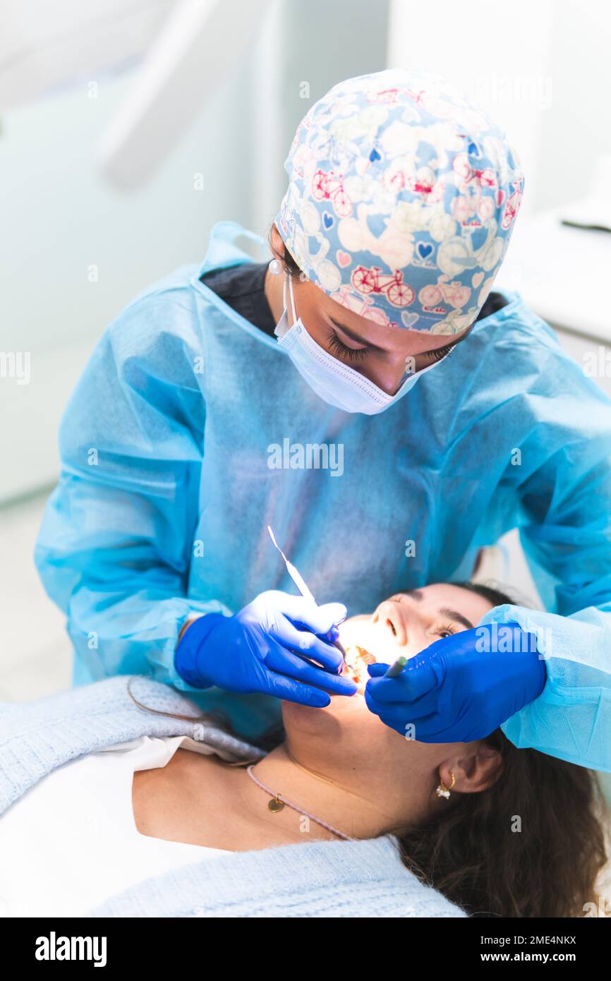 Dentist examining young patient's teeth hi-res stock photography and ...