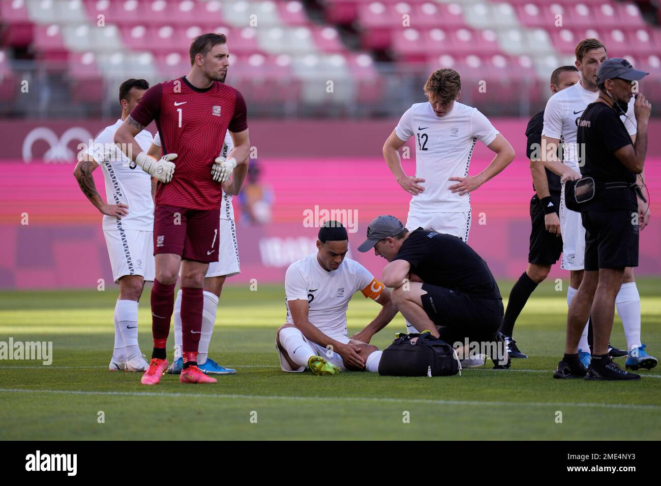 New Zealand's Winston reid, center, receives medical attention during a ...