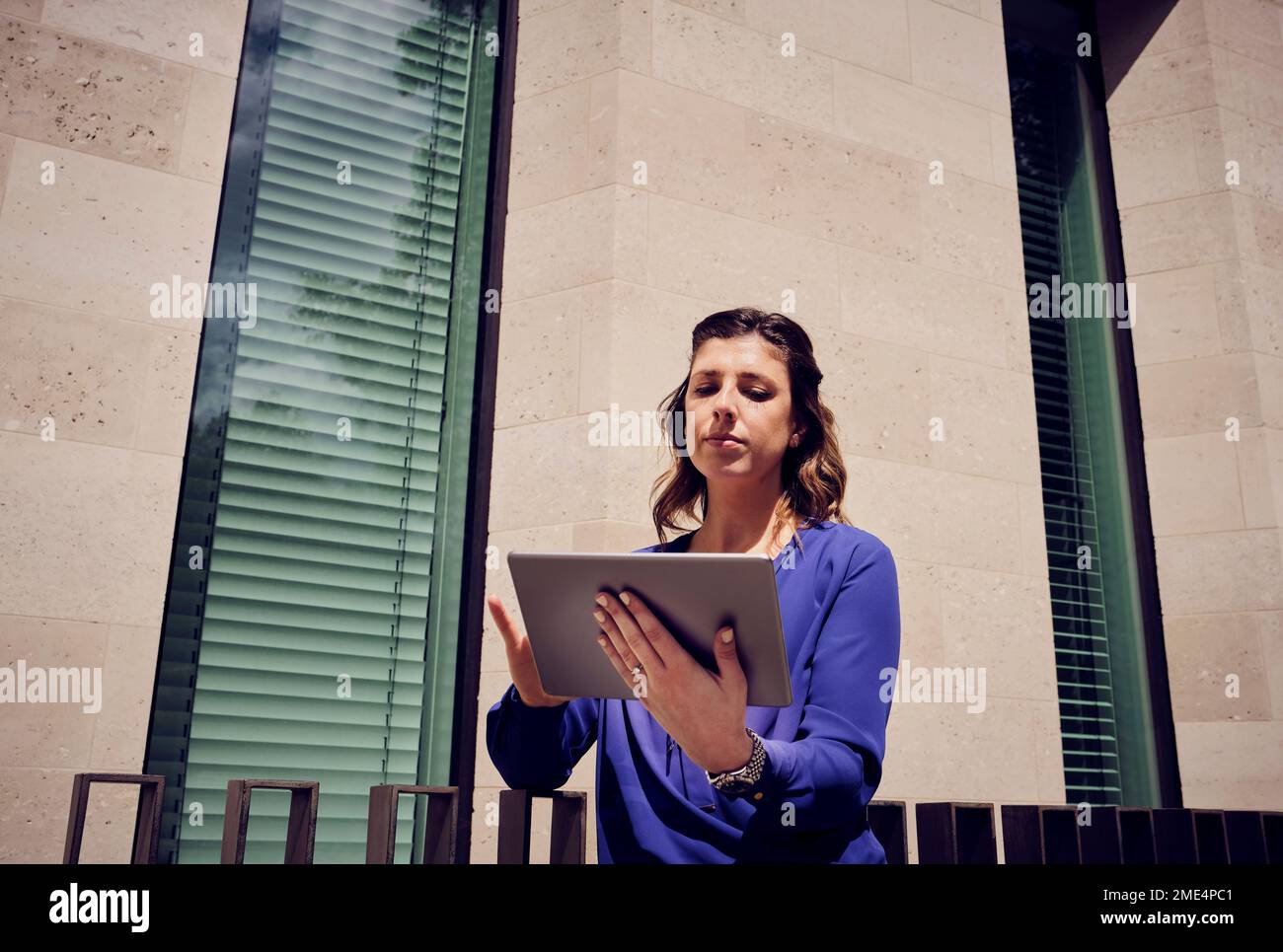 Young businesswoman using tablet computer on sunny day Stock Photo - Alamy
