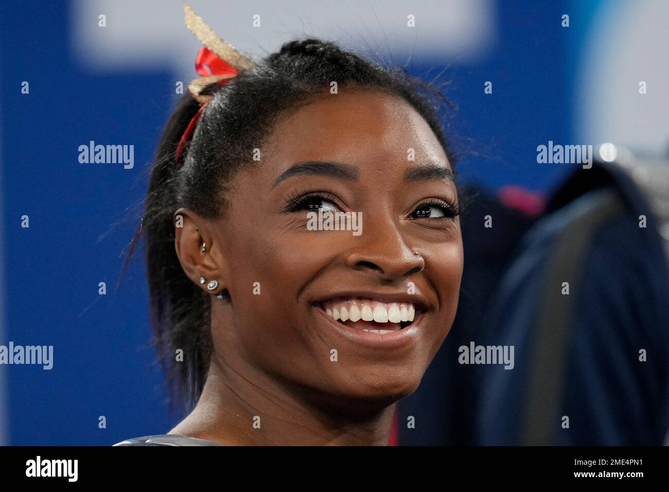 Simone Biles, of the United States, smiles after performing on the ...