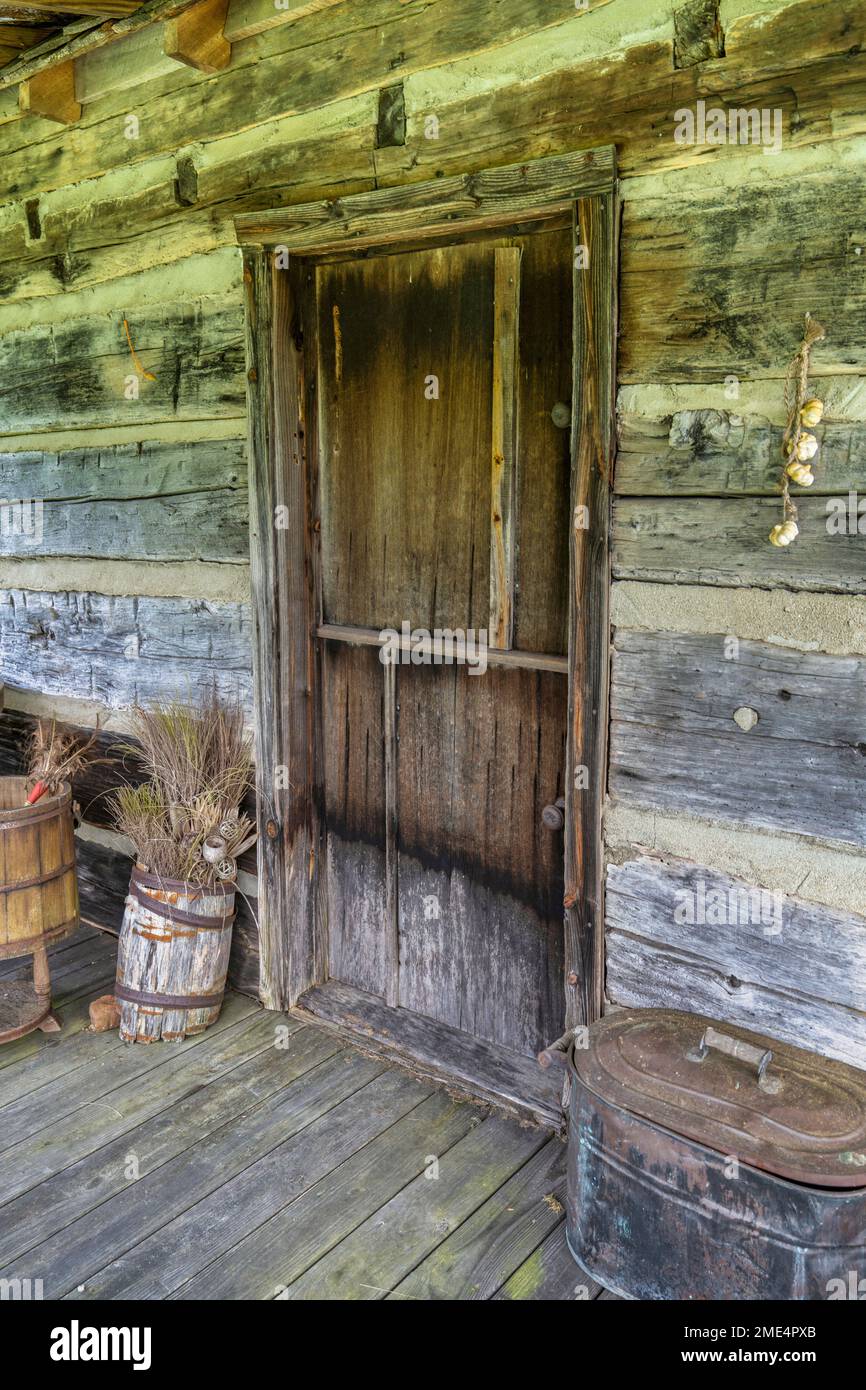 The rustic rear porch of a pioneer cabin at the Whippoorwill Academy ...