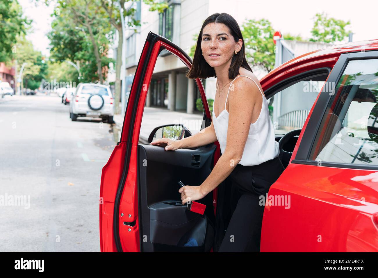 Woman getting car road hi-res stock photography and images - Alamy