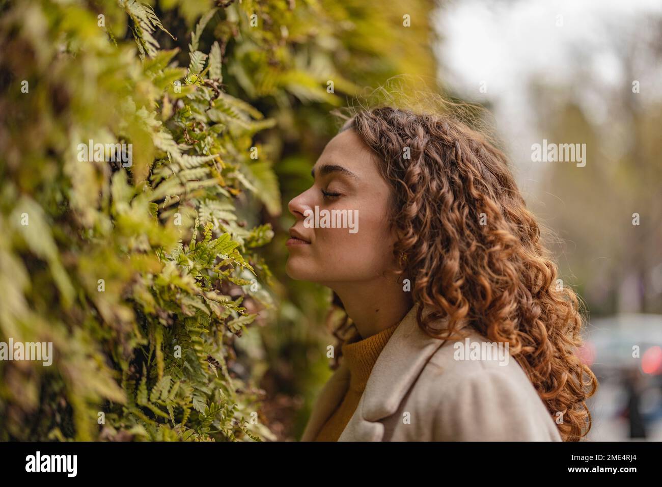 Young woman smelling clothes hi-res stock photography and images - Alamy