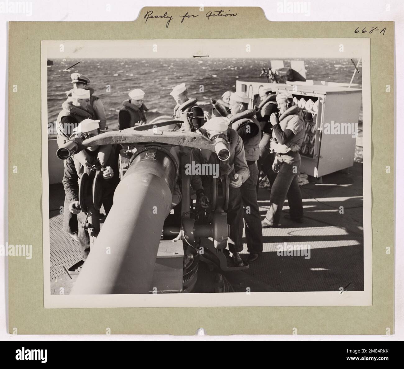 Coast Guardsmen man their gun stations aboard a Coast Guard vessel ...