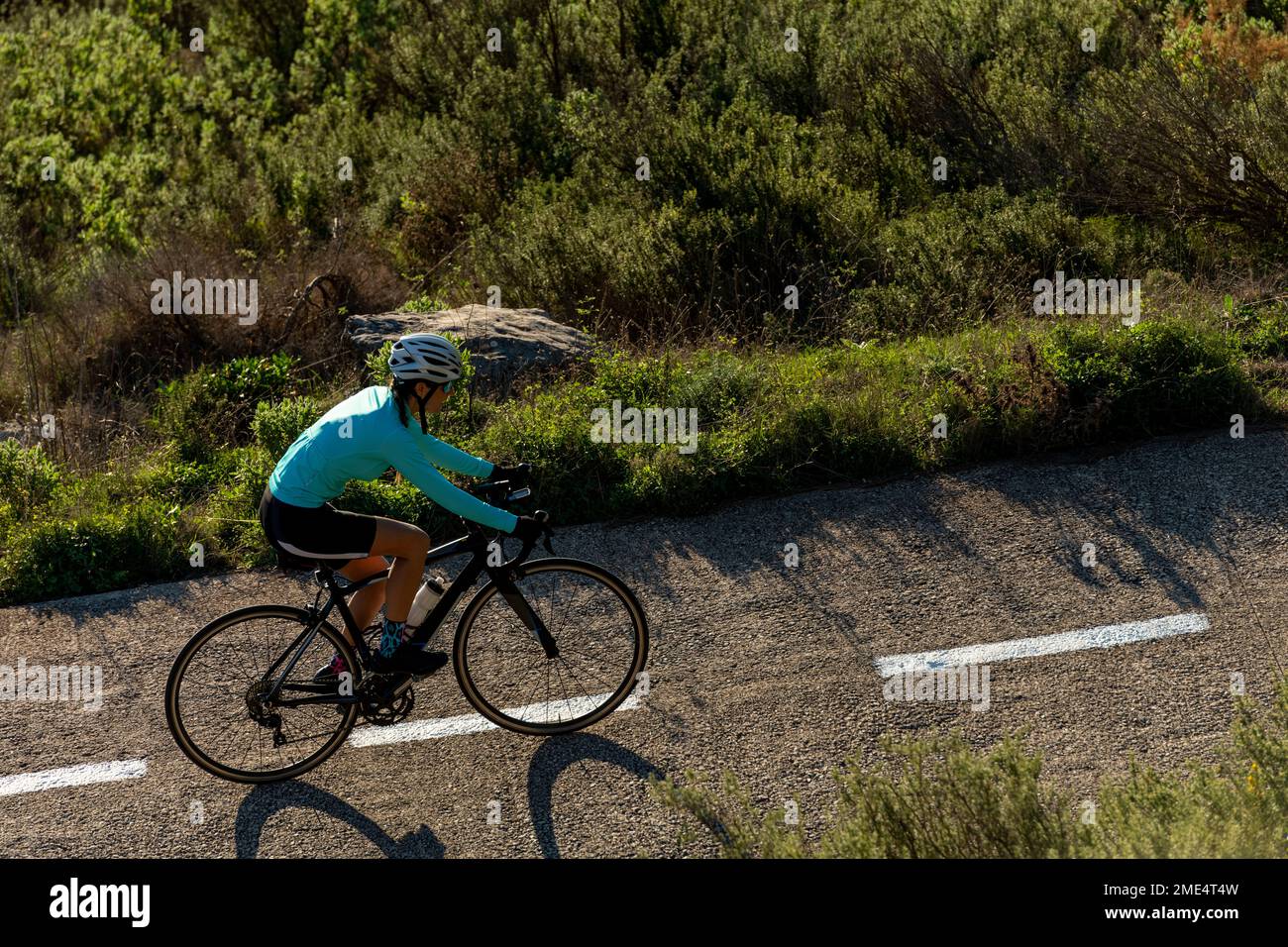 Cyclist riding on narrow hi-res stock photography and images - Alamy