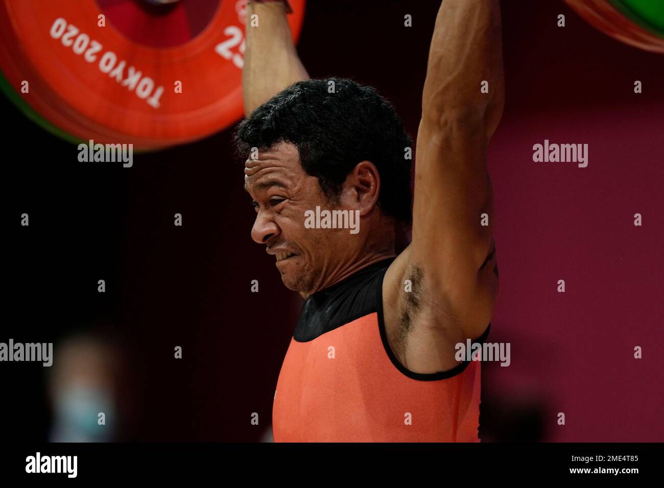 Morea Baru of Papa New Guinea competes in the men's 61kg weightlifting ...