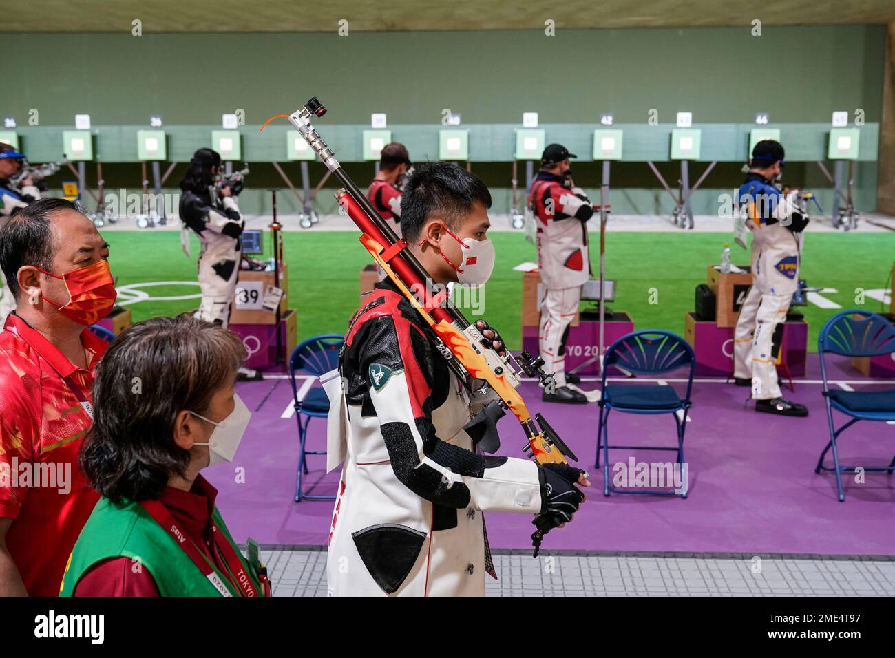 Yang Haoran, of China, walks with his rifle after competing in the men ...