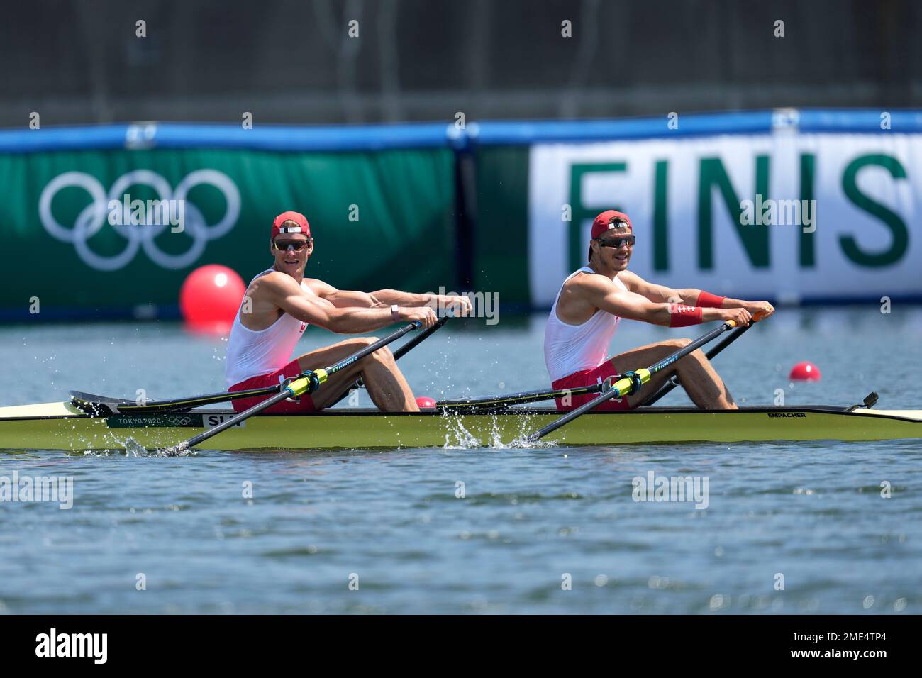 Barnabe Delarze and Roman Roeoesli of Switzerland cross the finish line ...
